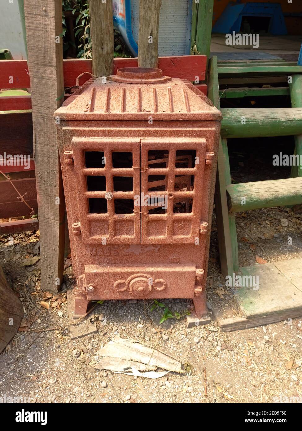 shot of an old rusty rural cast iron heating stove that burnt wood or ...