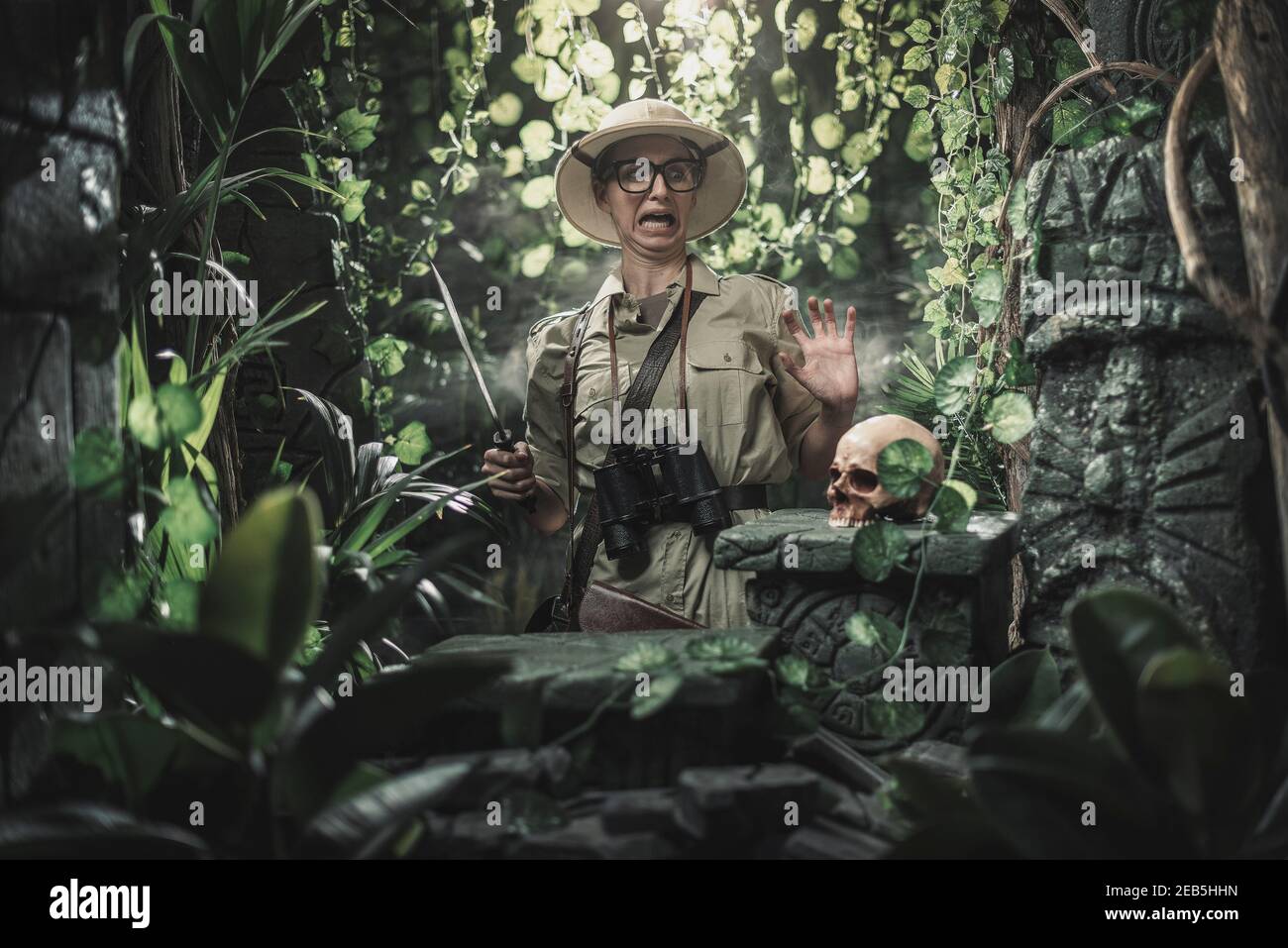 Scared explorer walking in the jungle and finding a human skull, she is ...