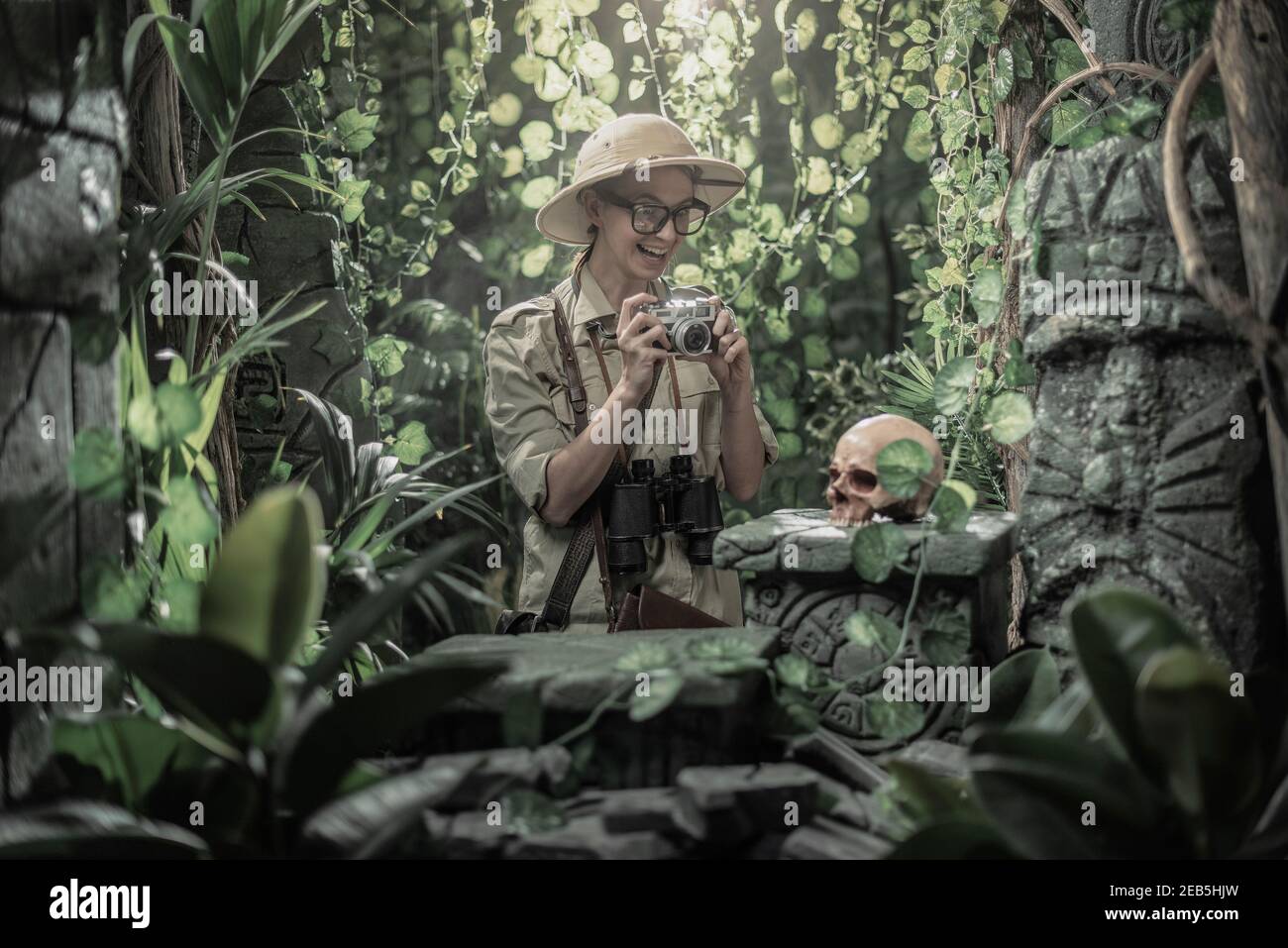 Brave woman exploring the jungle and taking pictures with her camera ...