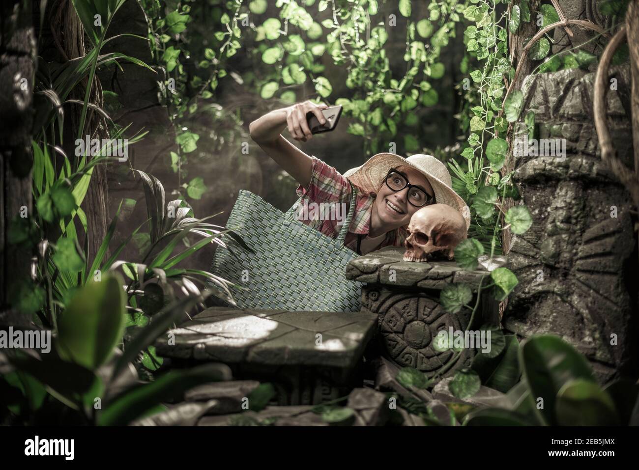 Funny tourist exploring the forest and ancient ruins, she is taking a ...