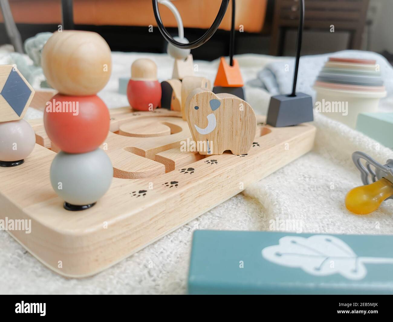 Gender neutral wooden bead toy in soft colors. Gender-neutral parenting ...