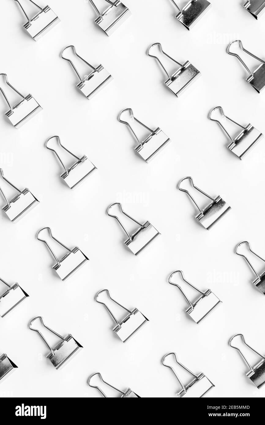 Stationery pattern. Paper binder clips top view Stock Photo - Alamy