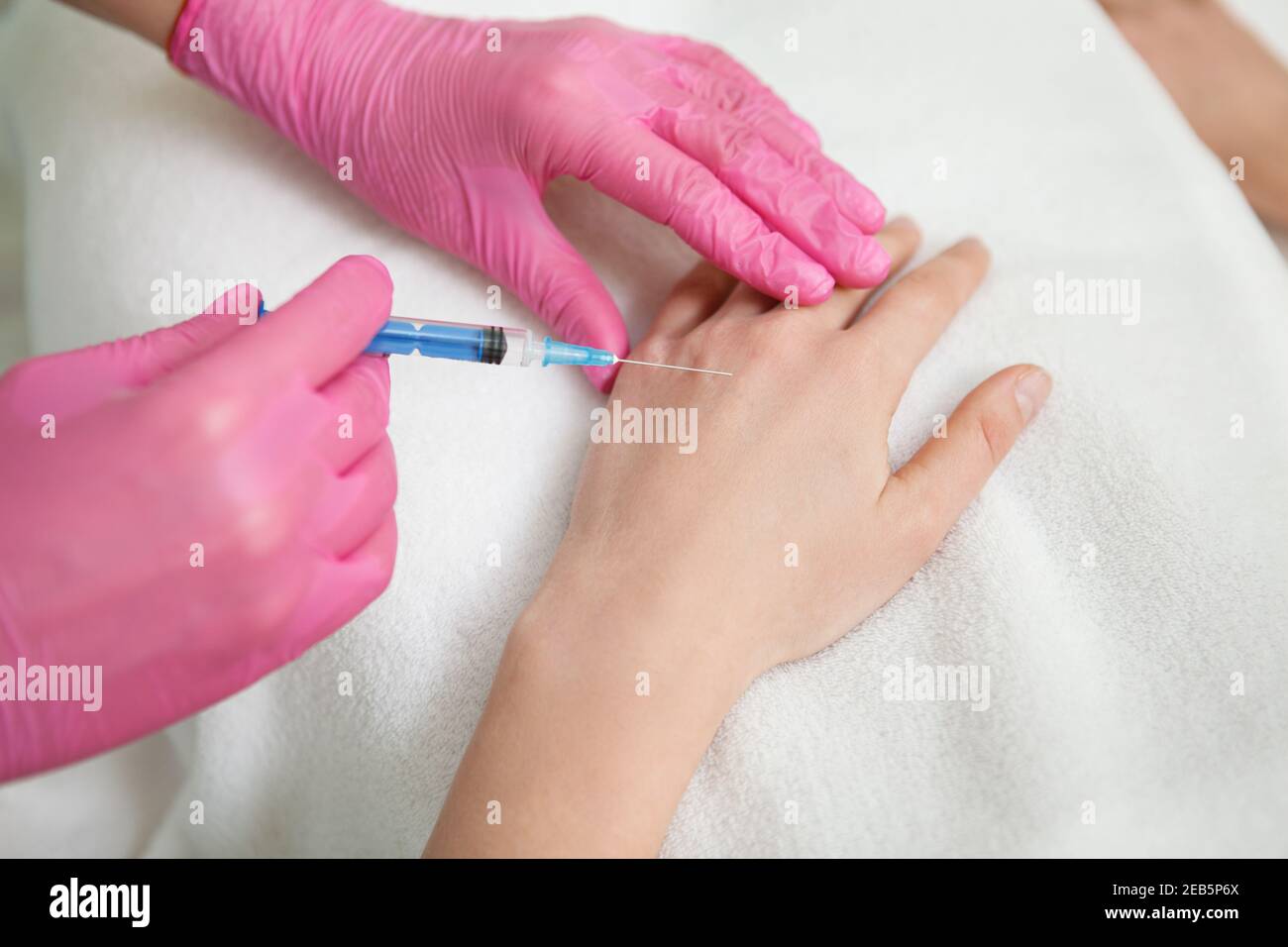 Close up of a professional cosmetologist giving rejuvenations ...