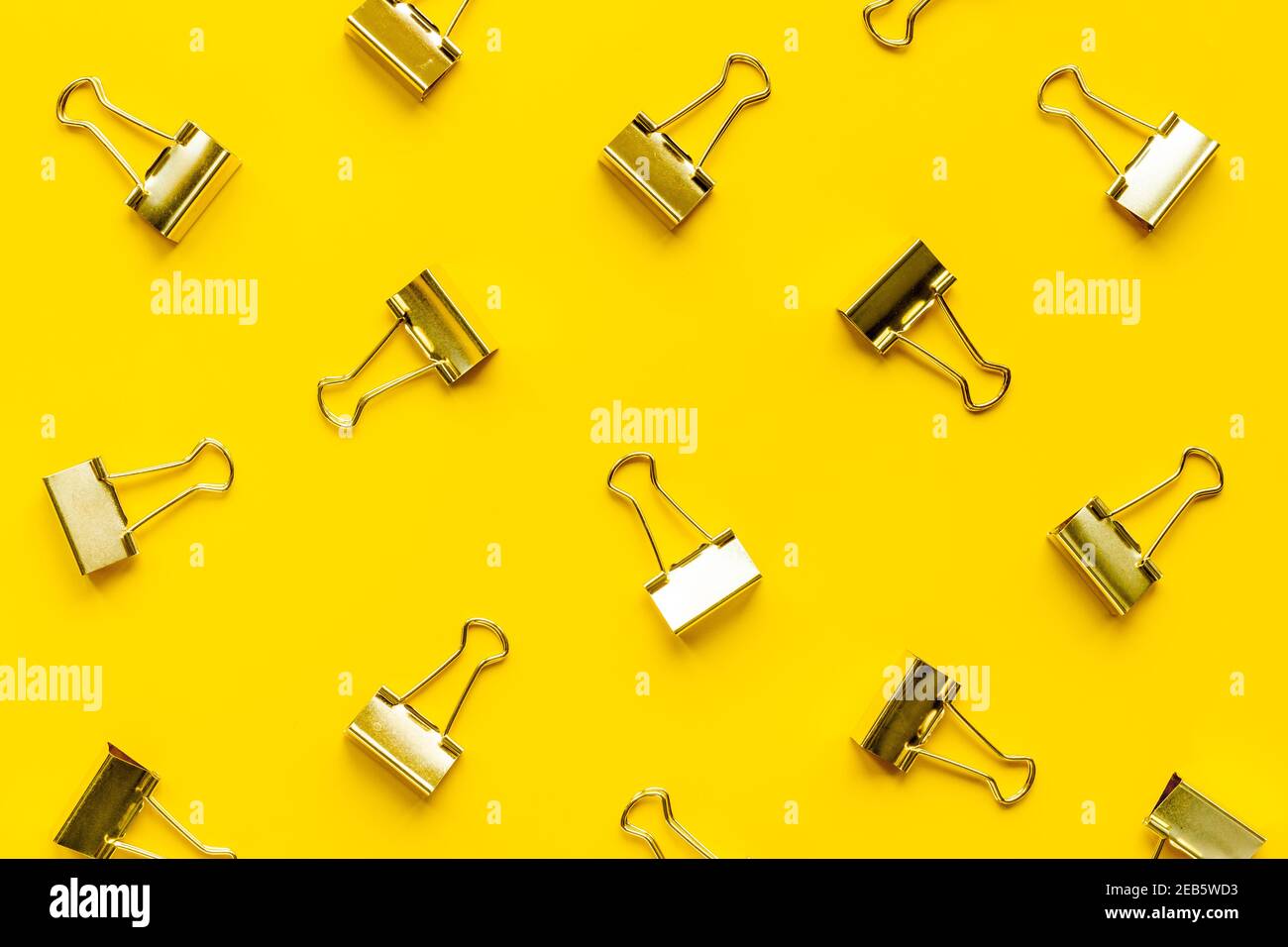 Stationery pattern. Paper binder clips top view Stock Photo - Alamy