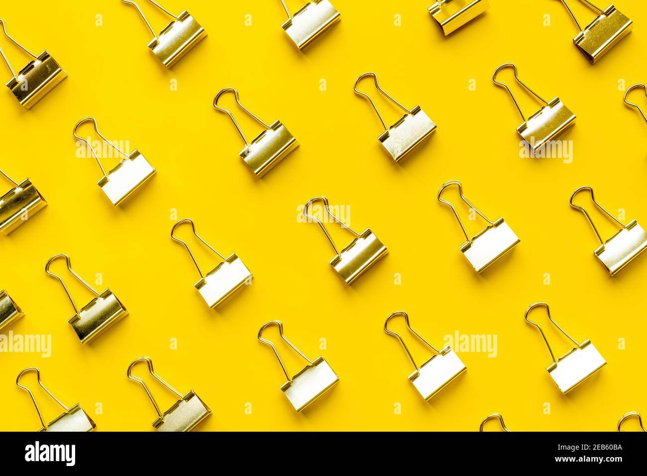 Stationery pattern. Paper binder clips top view Stock Photo - Alamy