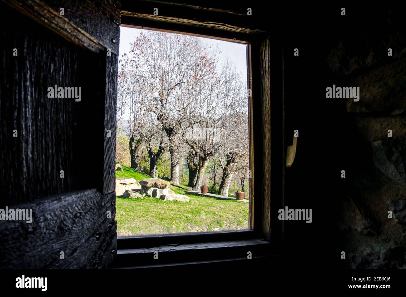 Interior view from the window of a rustic house towards a beautiful ...