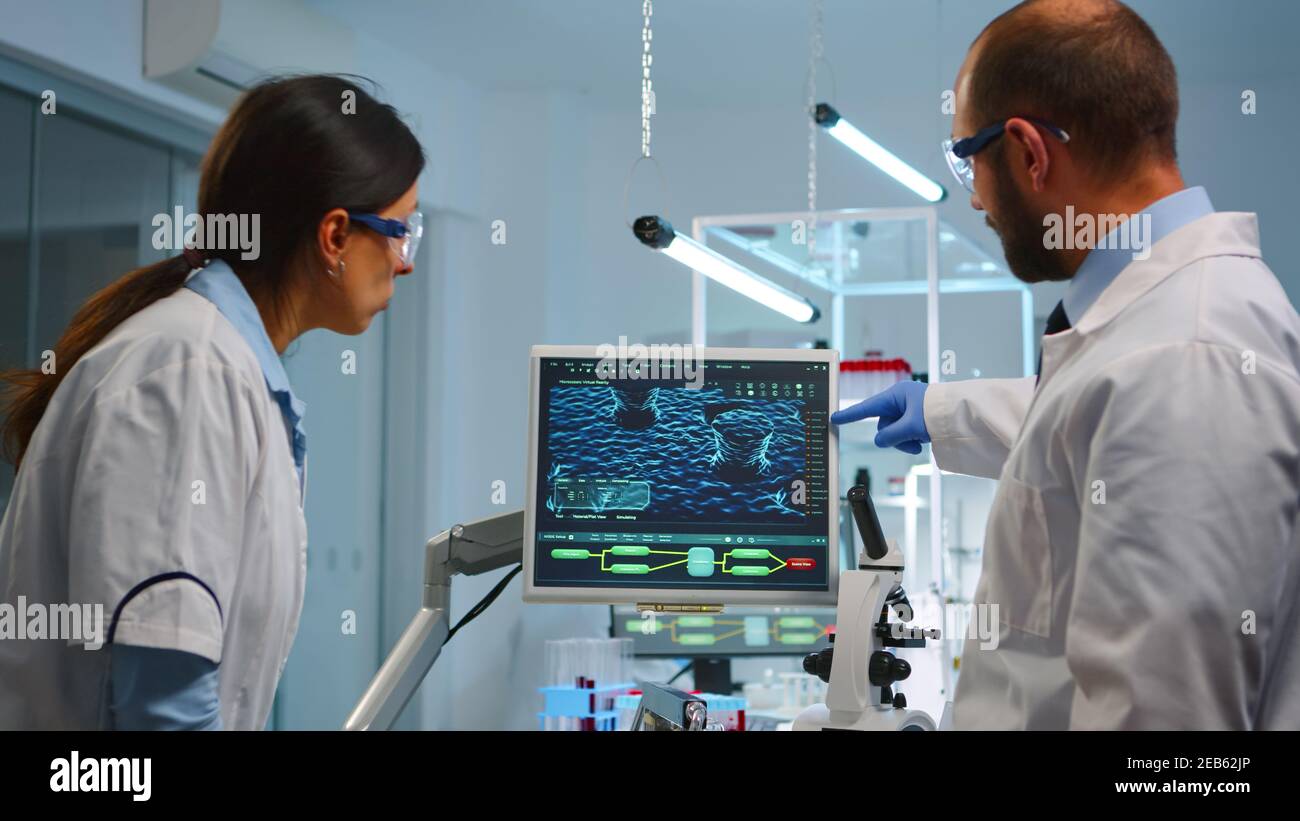 Lab technicians making pharmaceutical research for antibiotics, curing ...