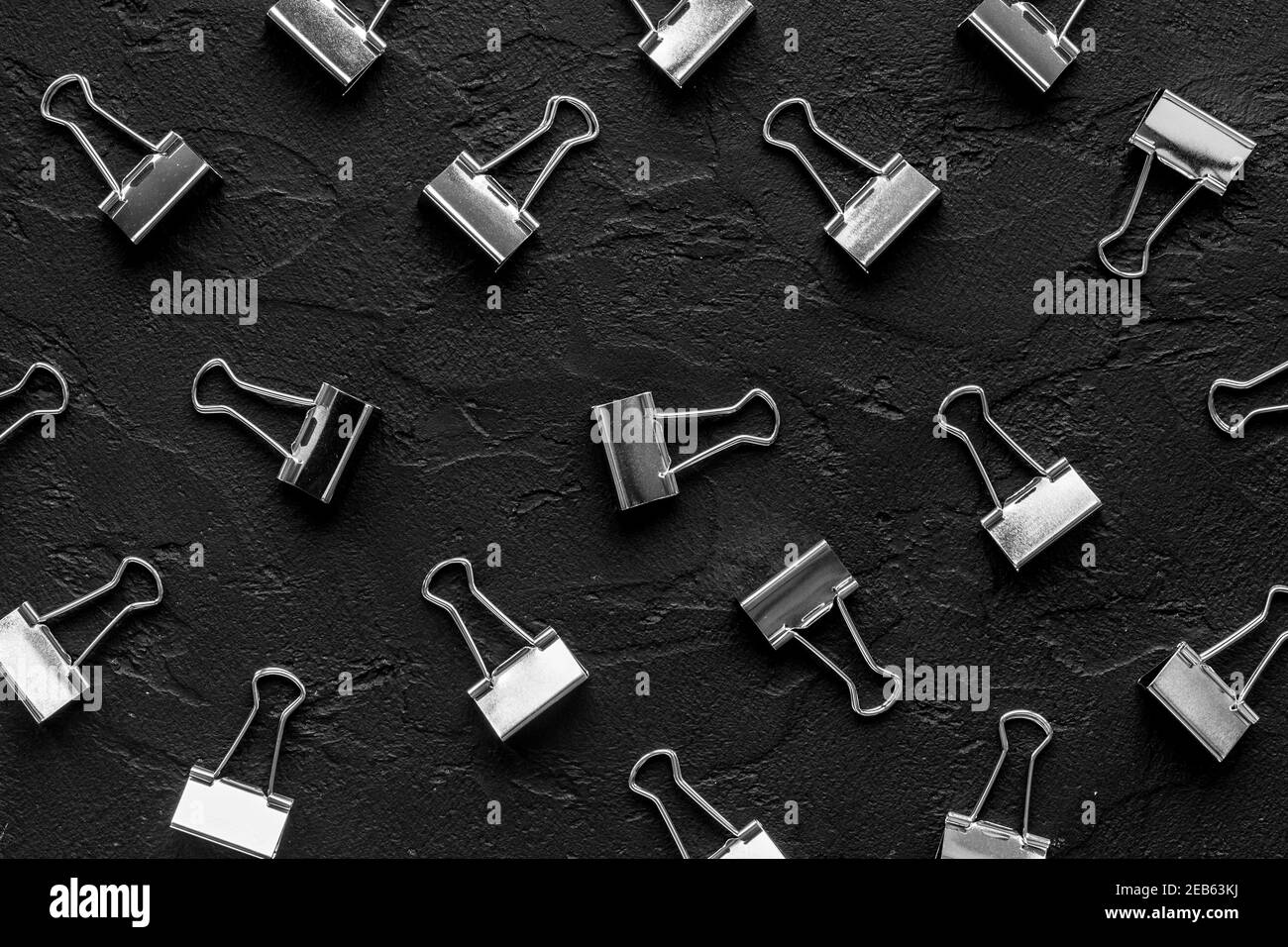 Stationery pattern. Paper binder clips top view Stock Photo - Alamy