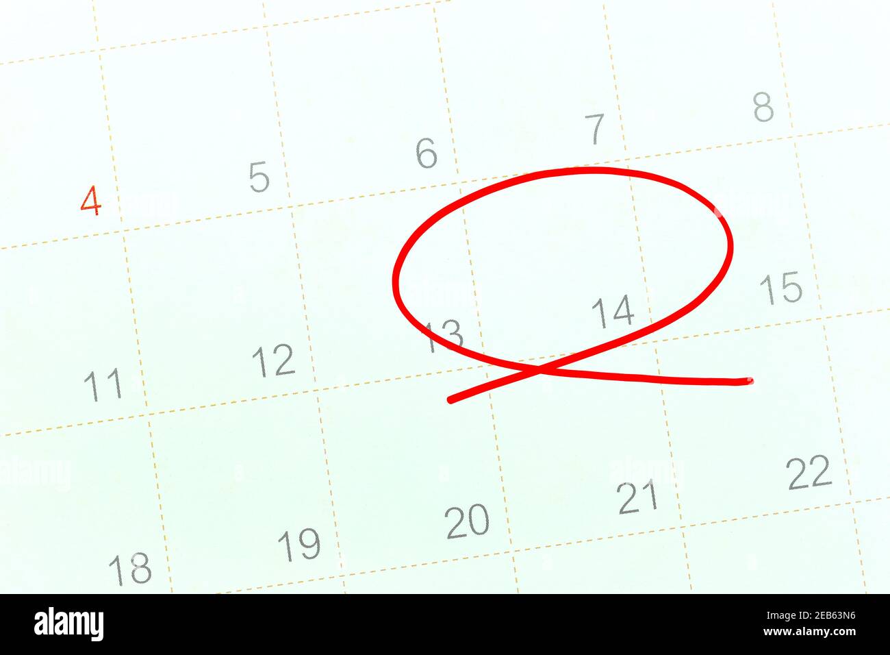 Red circle of the pen on the calendar paper shows the 14th for design ...