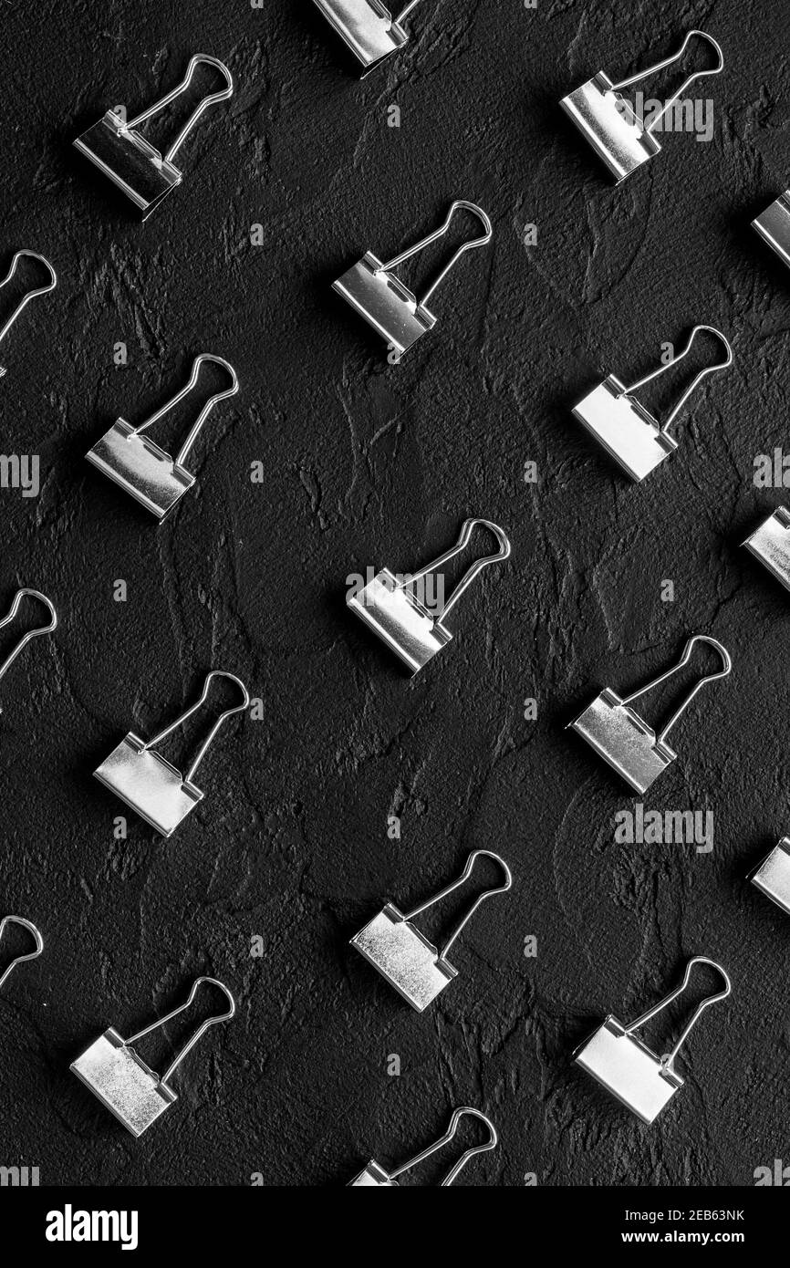 Stationery pattern. Paper binder clips top view Stock Photo - Alamy
