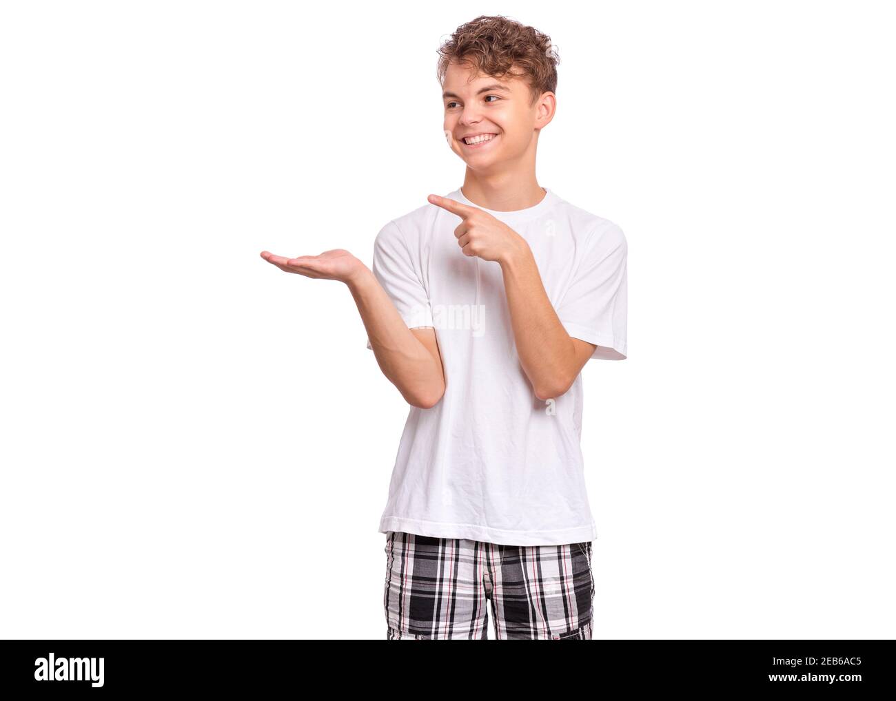 Cute teen boy pointing up, gesturing idea or doing number one gesture ...