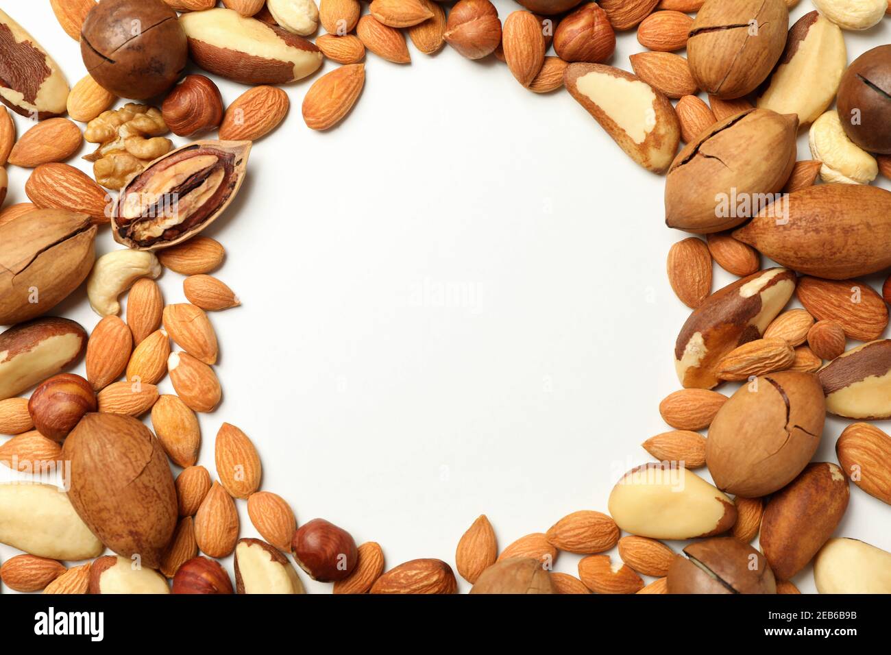 Different tasty nuts on white background, space for text Stock Photo ...