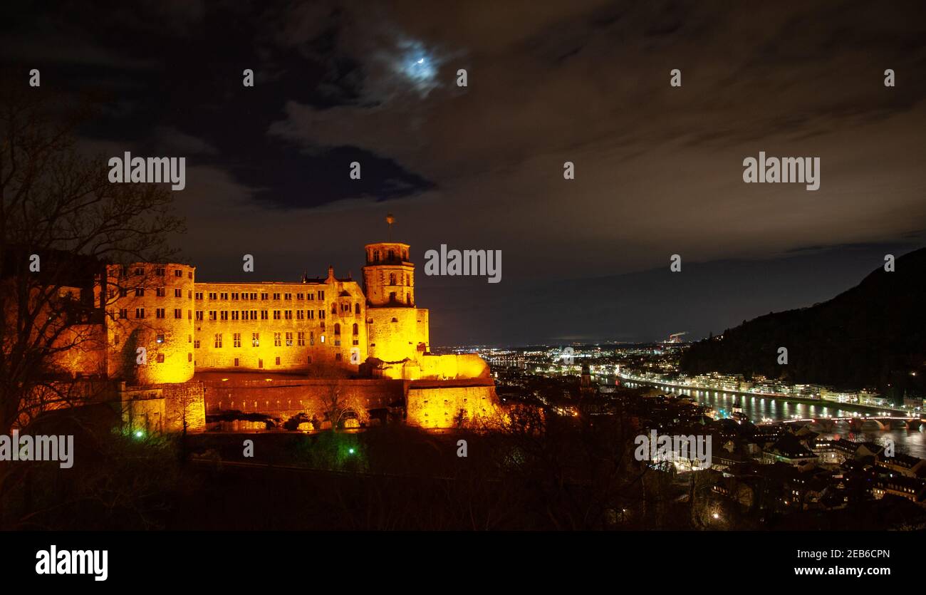 Heidelberg Castle in Germany under moonlight showing lights of old town ...