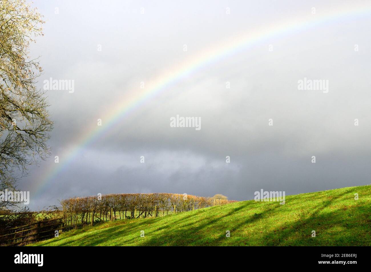 Rainbow over open countryside after storm Stock Photo - Alamy
