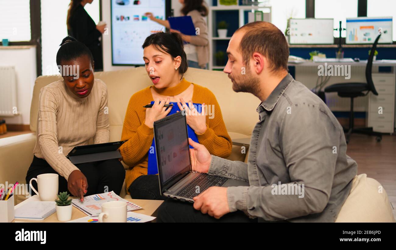 Confident company manager giving working tasks to diverse teammates ...