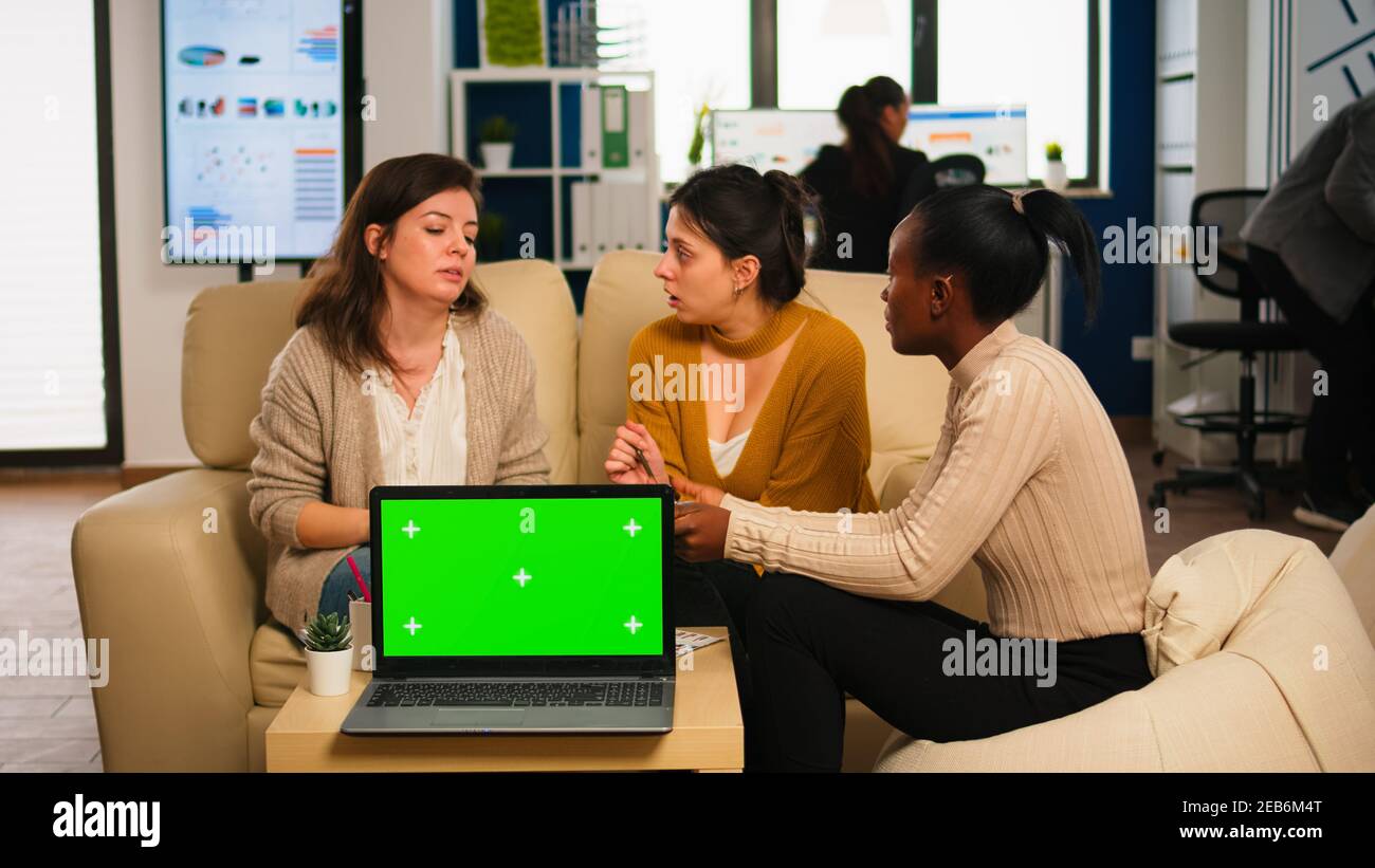 Diverse businesswomen analysing annual financial reports sitting on ...