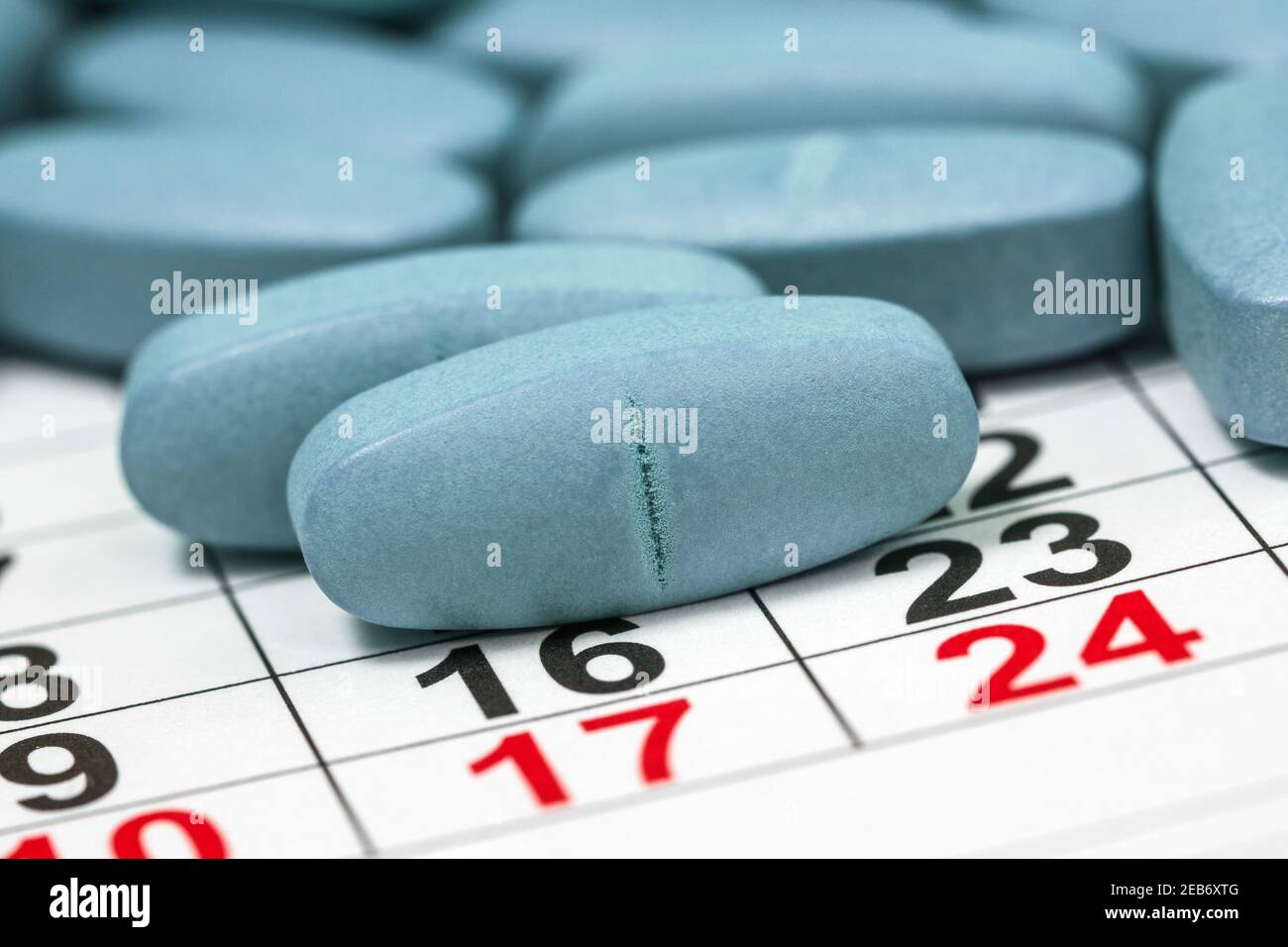 Blue medical pills on a monthly calendar. Medication plan, schedule ...