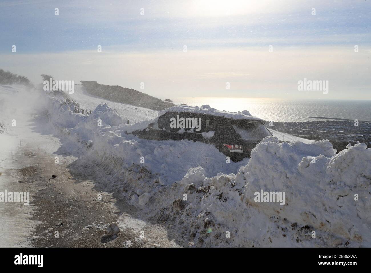 A Range Rover is buried under snow on Crete Road in Folkestone, Kent ...