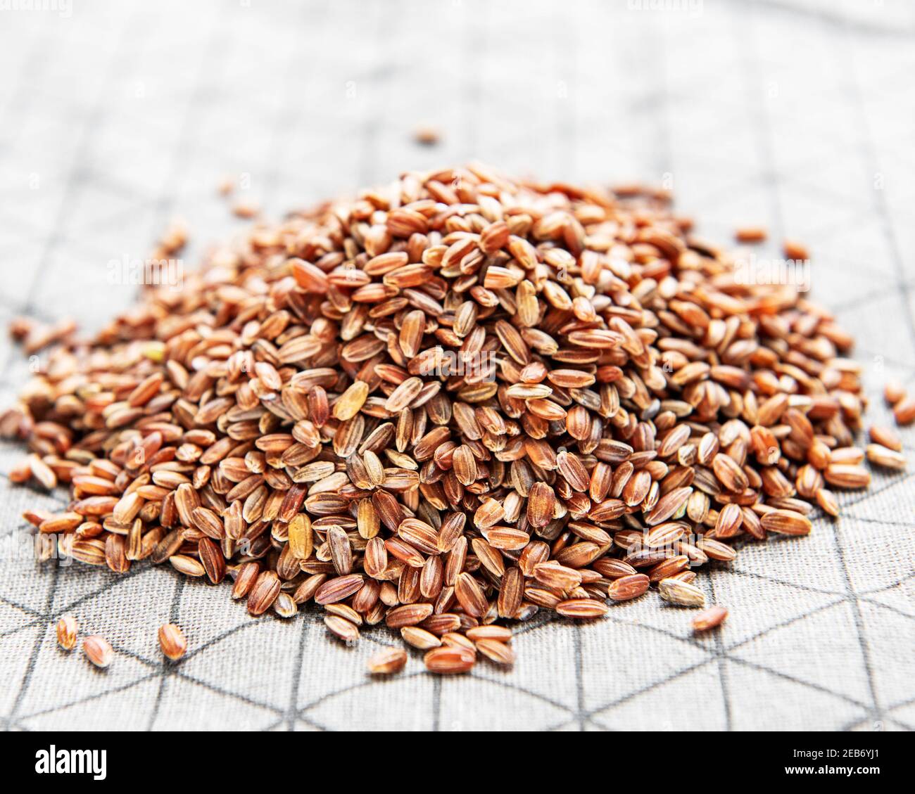 Raw red rice on a textile background Stock Photo - Alamy