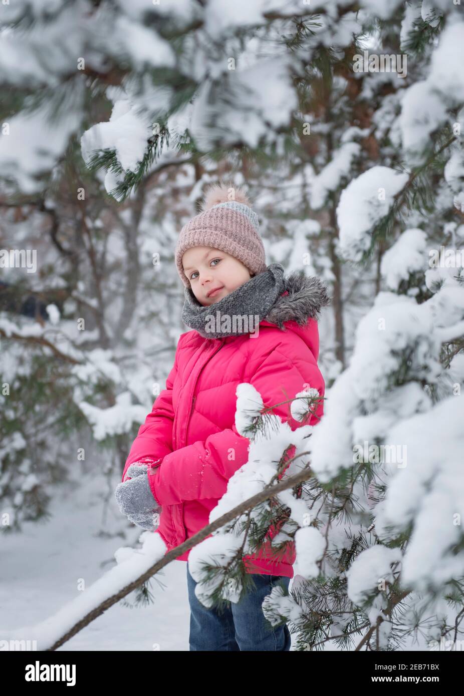 Child in winter. A little girl, playing in the winter outside. A ...