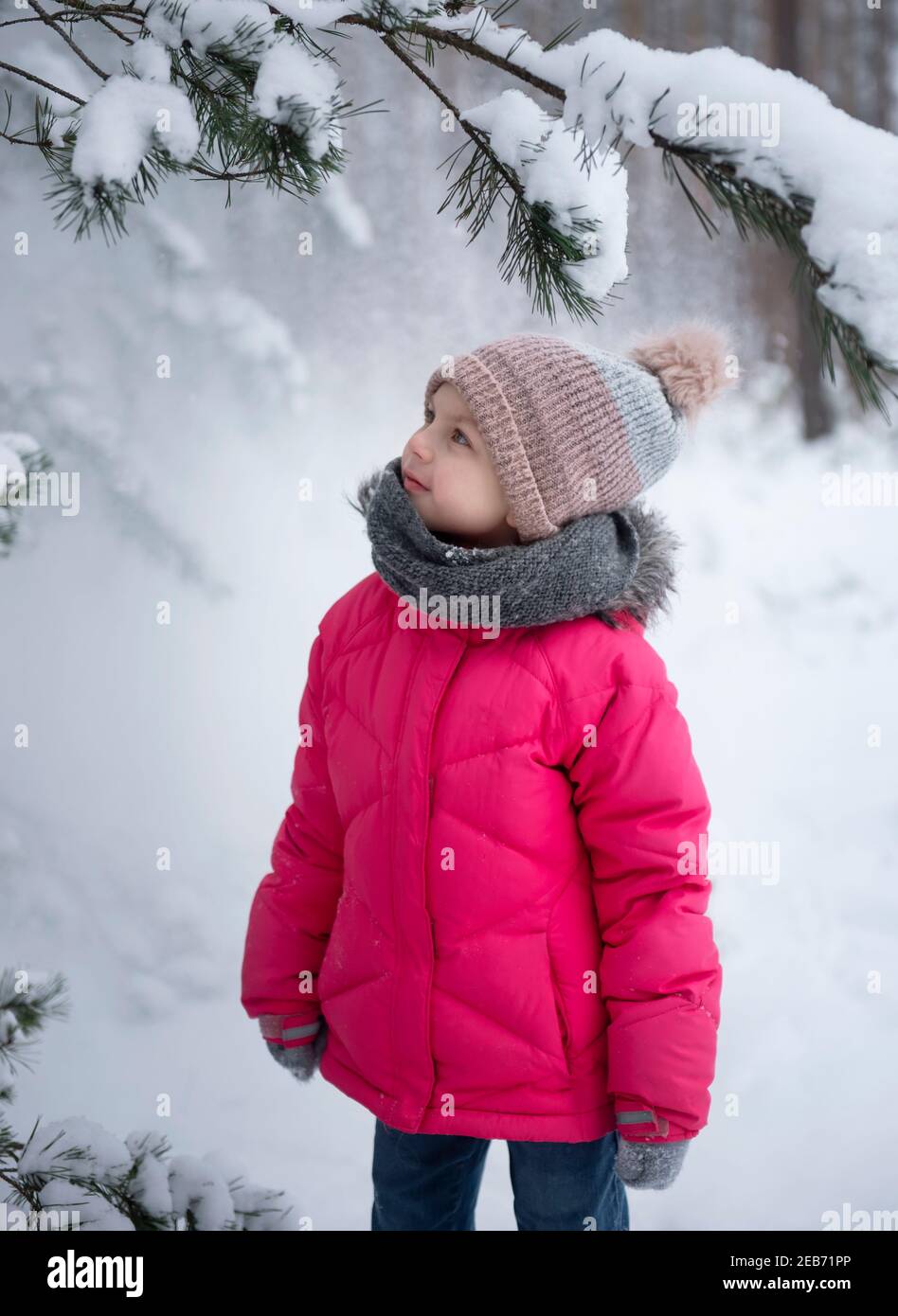 Child in winter. A little girl, playing in the winter outside. A ...