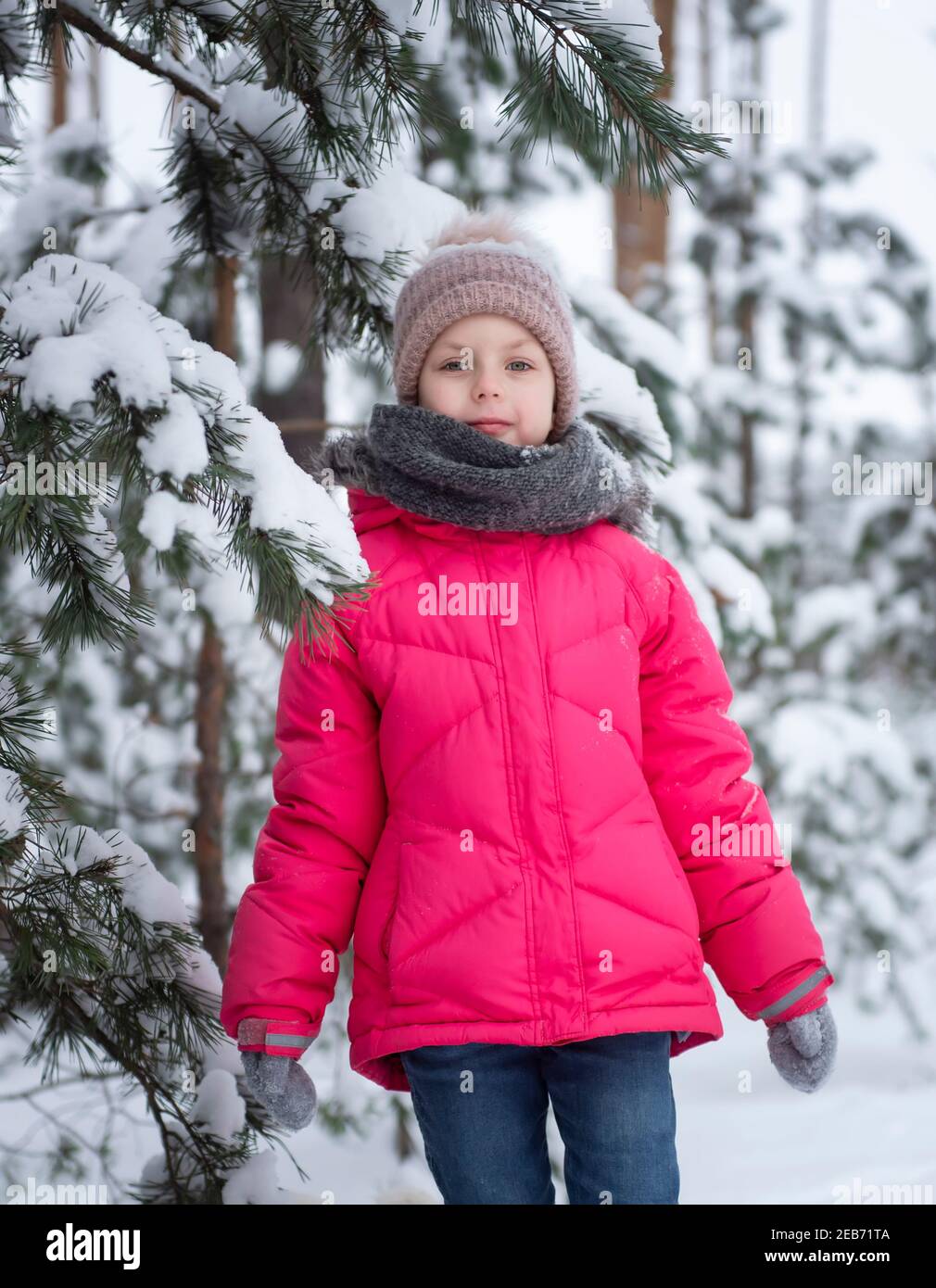 Child in winter. A little girl, playing in the winter outside. A ...