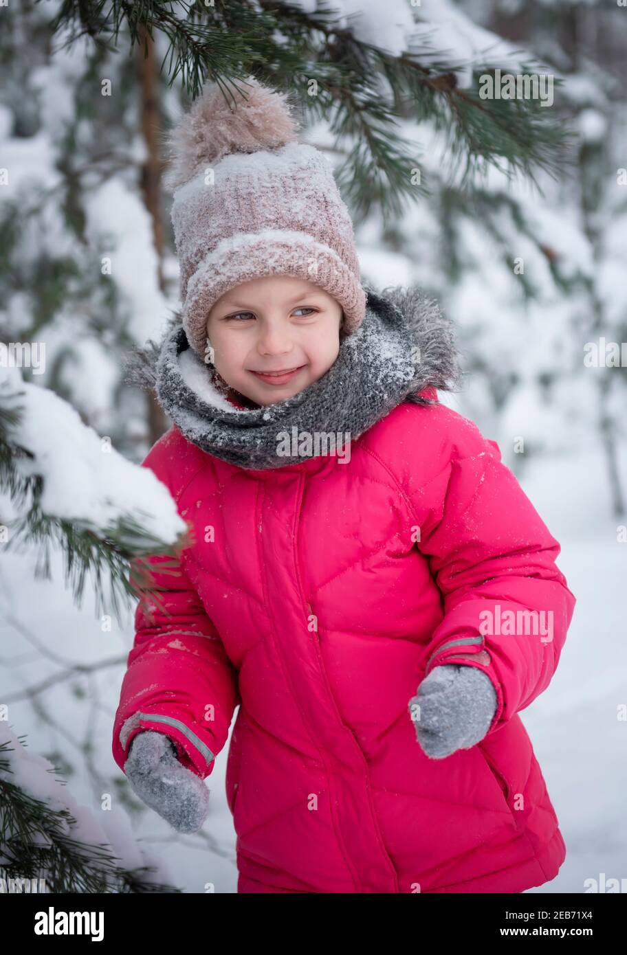 Child in winter. A little girl, playing in the winter outside. A ...