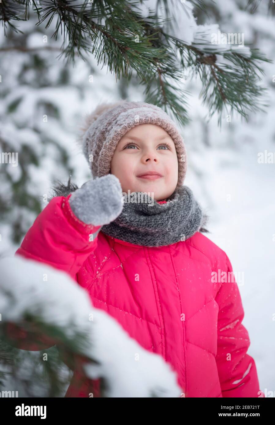 Child in winter. A little girl, playing in the winter outside. A ...