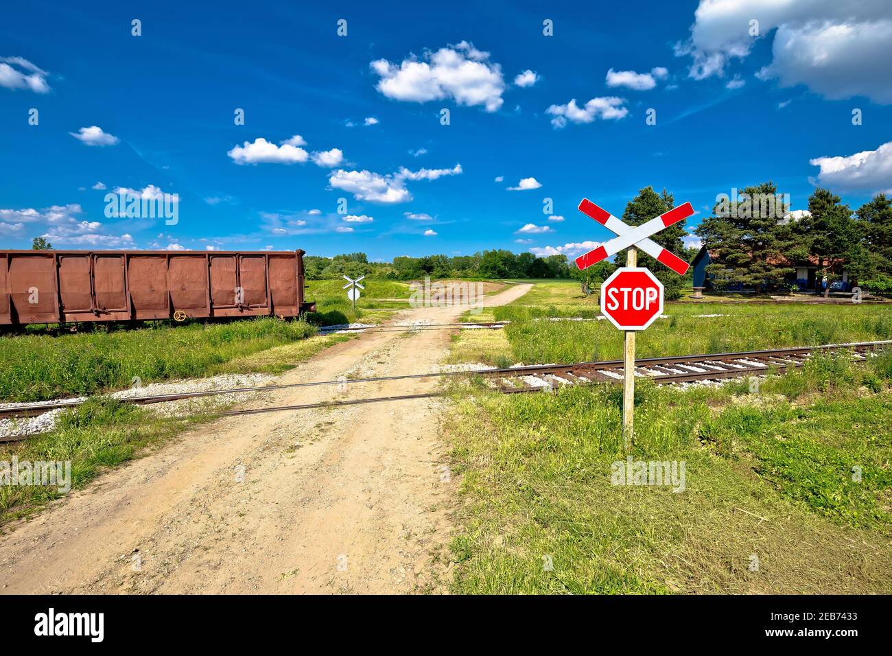 Unprotected railroad crossing country road view. Podravina region green ...