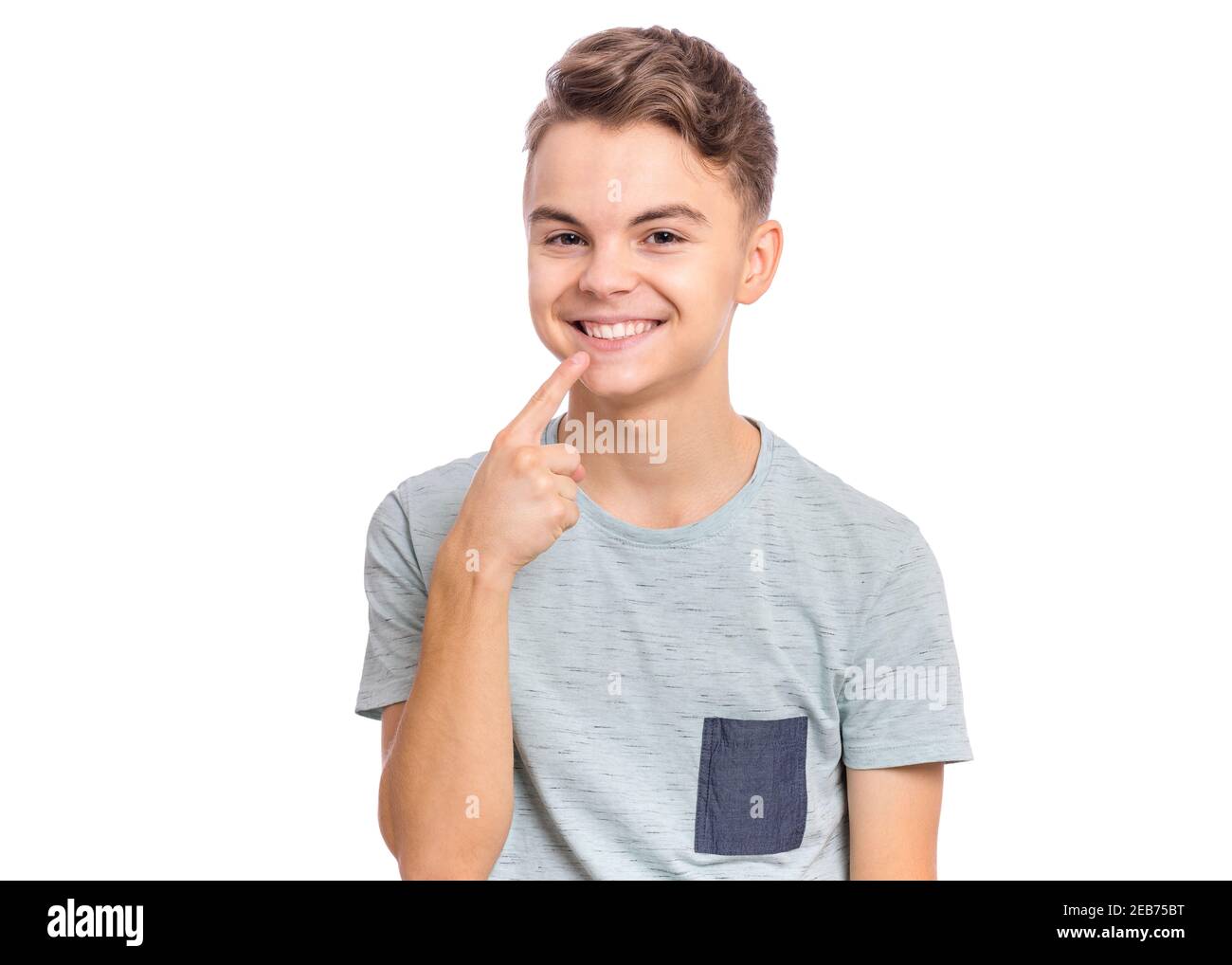 Handsome teen boy showing his to teeth, isolated on white background ...