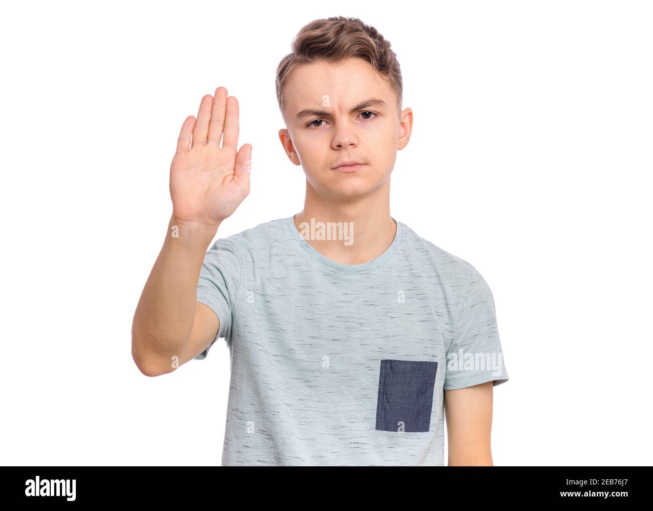 Handsome teen boy showing stop gesture with his palm, isolated on white ...