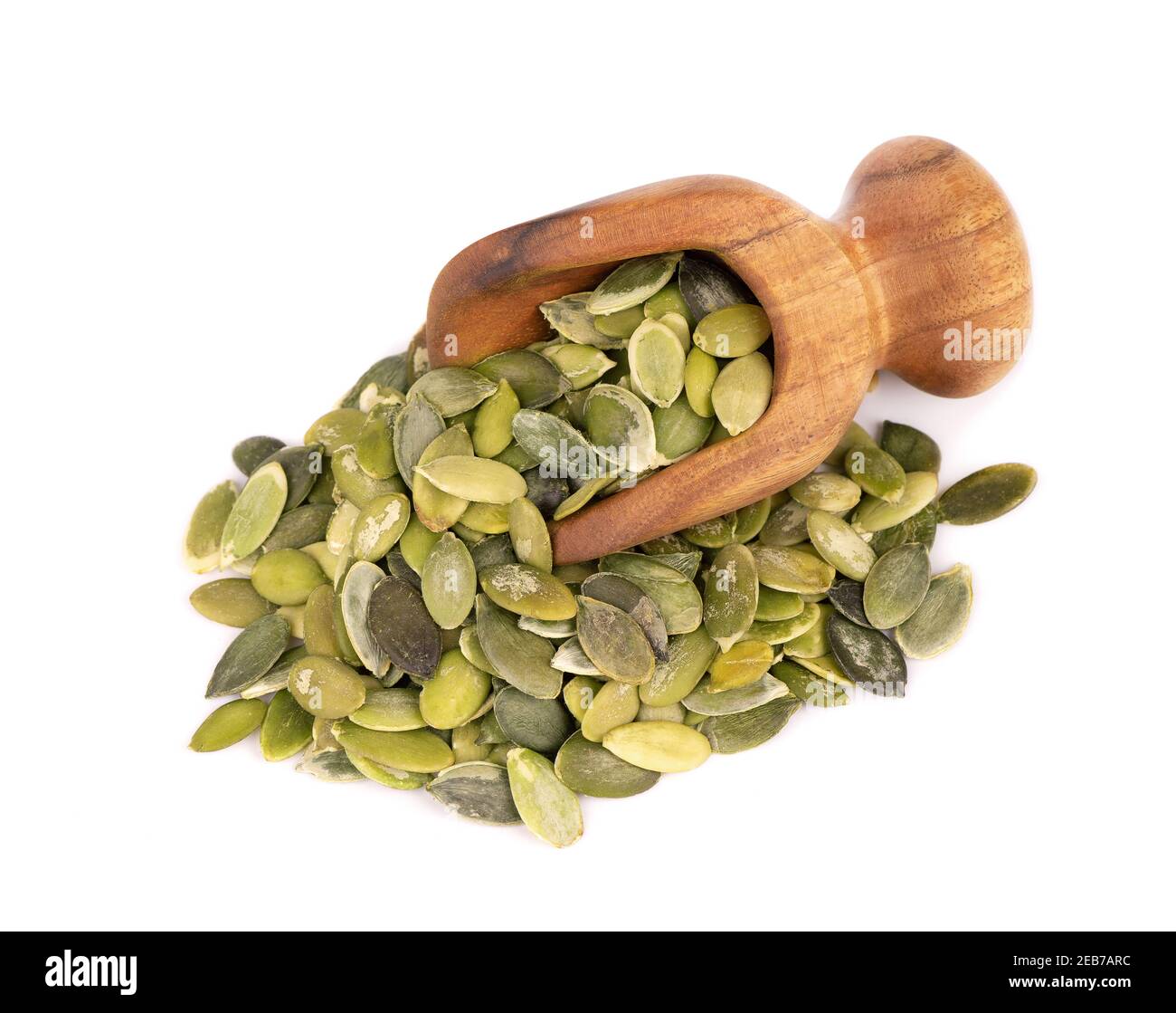 Pumpkin seeds in wooden scoop, isolated on white background. Green ...