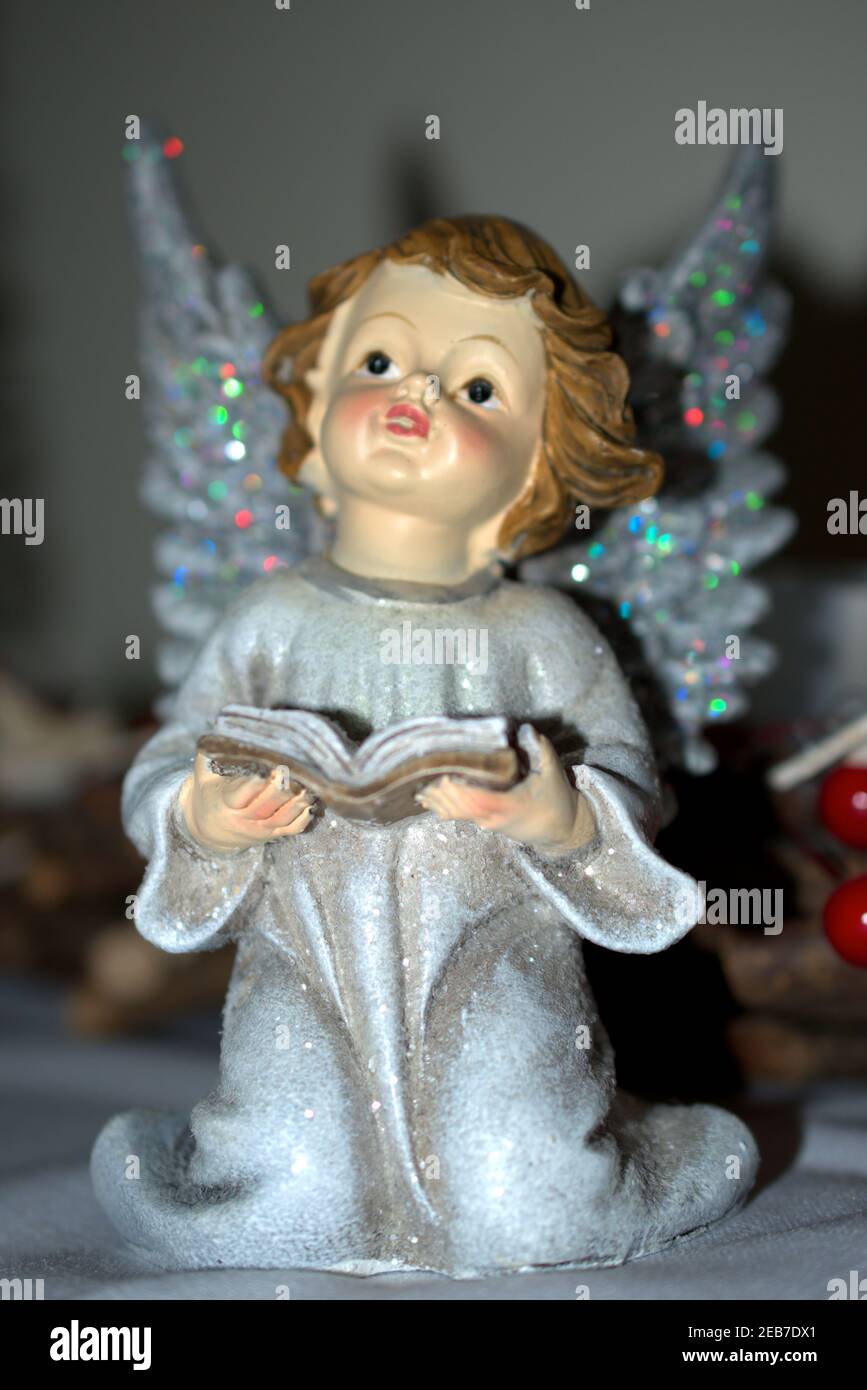 Angel holding book hi-res stock photography and images - Alamy