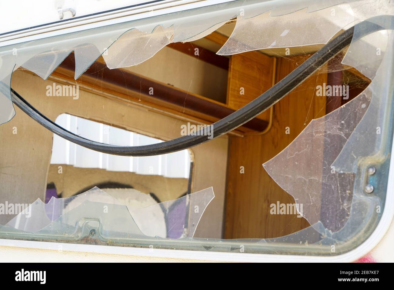 Broken glass of an abandoned room with wooden furniture Stock Photo - Alamy