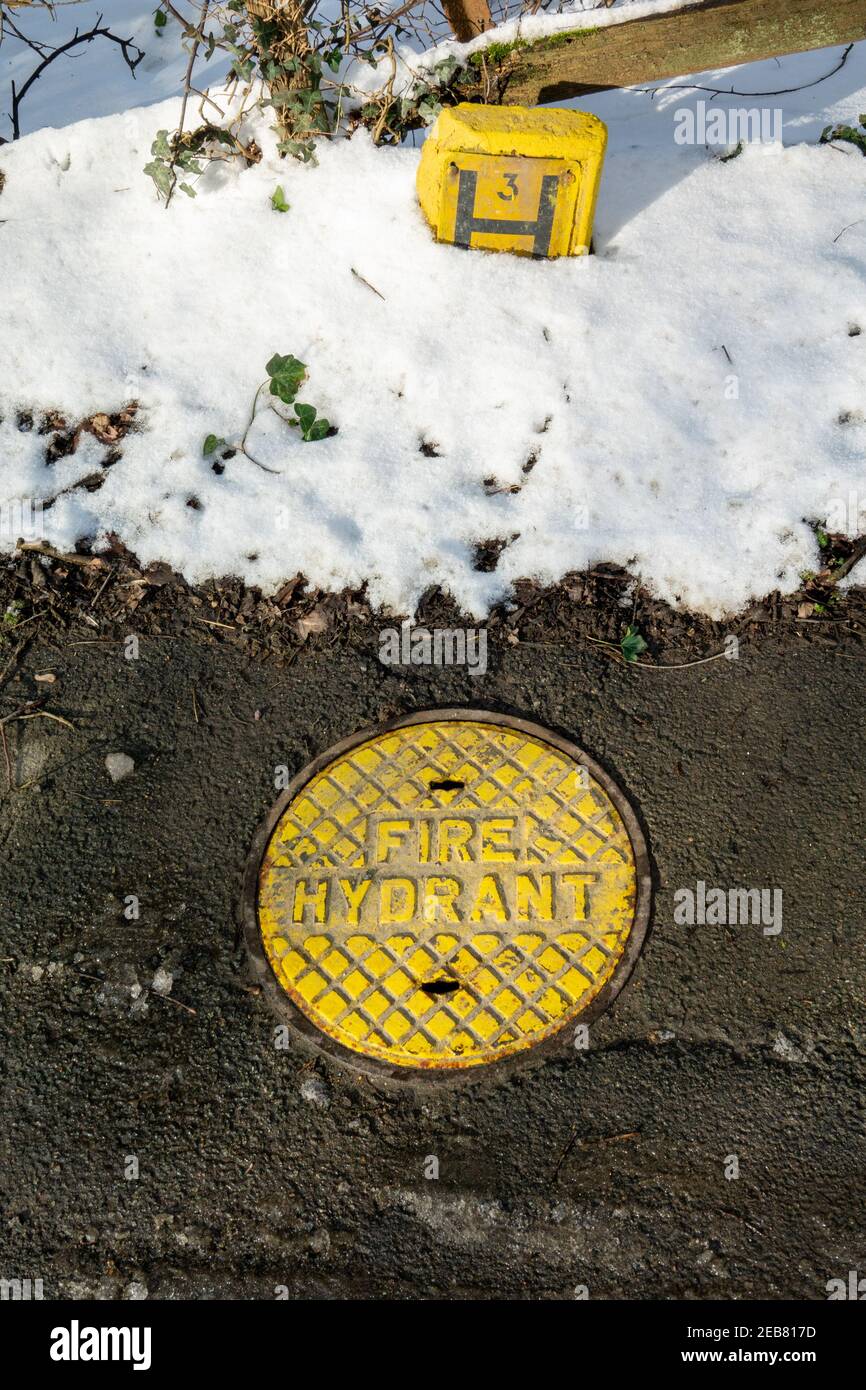 Yellow fire hydrant and sign Stock Photo - Alamy