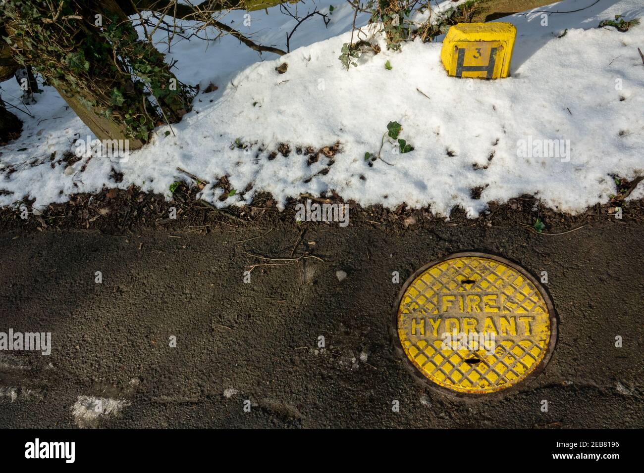 Yellow fire hydrant and sign Stock Photo - Alamy
