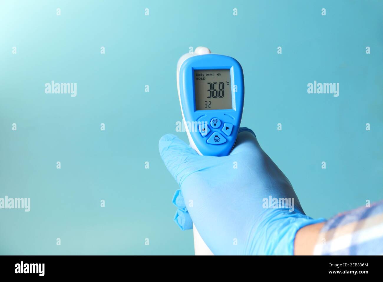 Hand holding infrared thermometer to measuring temperature Stock Photo ...