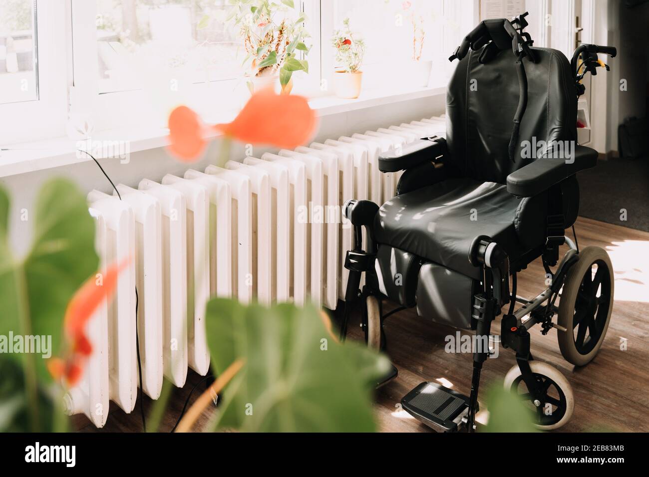photo of an empty handicap chair next to a window Stock Photo - Alamy