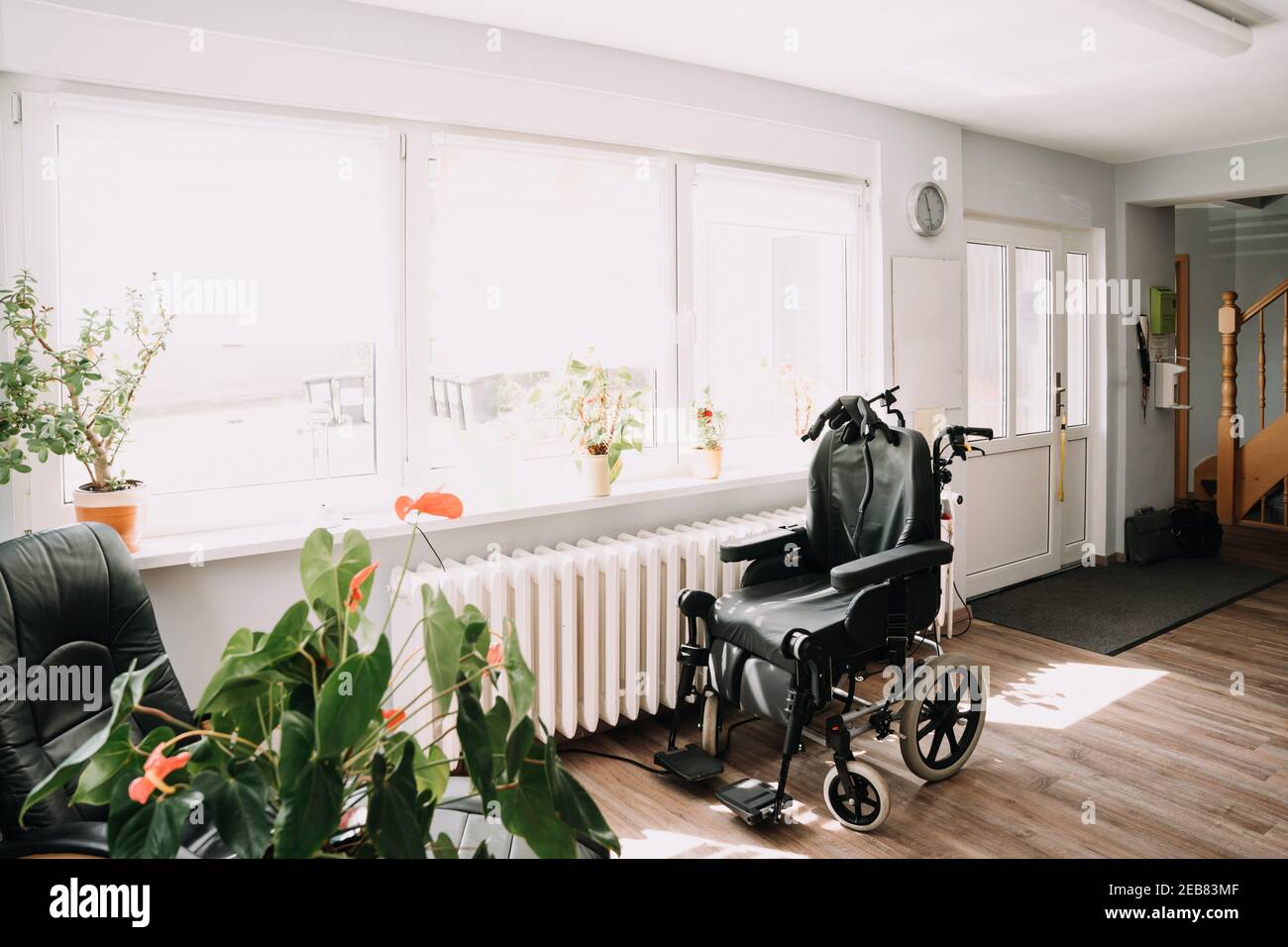 photo of an empty handicap chair next to a window Stock Photo - Alamy