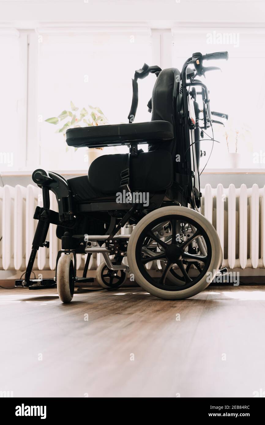 photo of an empty handicap chair next to a window Stock Photo - Alamy