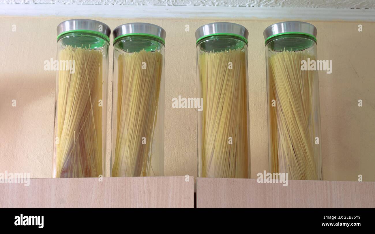 storing pasta on the kitchen cabinet in transparent tall glass jars ...
