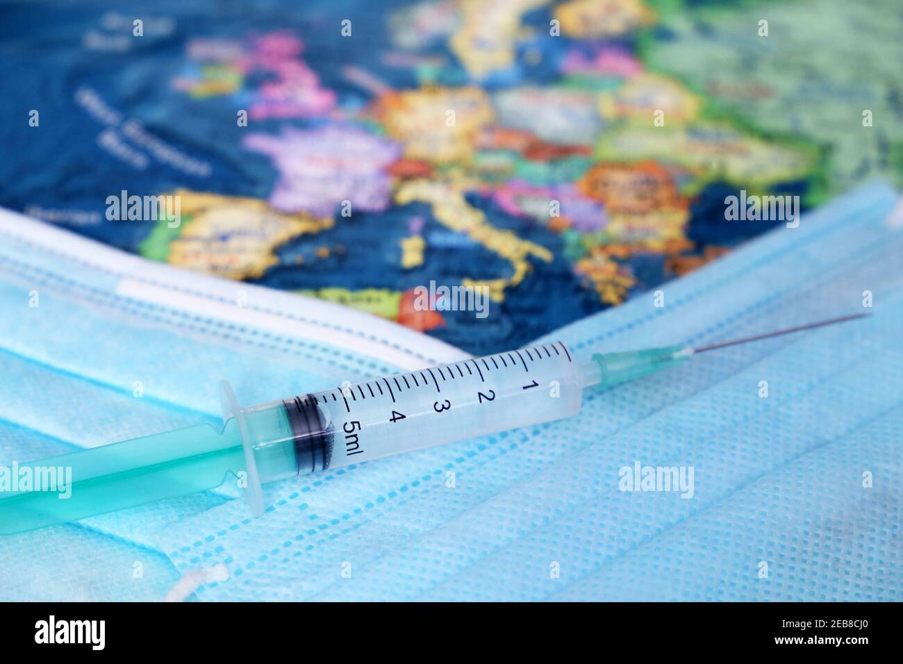 Vaccination in EU, syringe and medical masks on the map of Europe ...