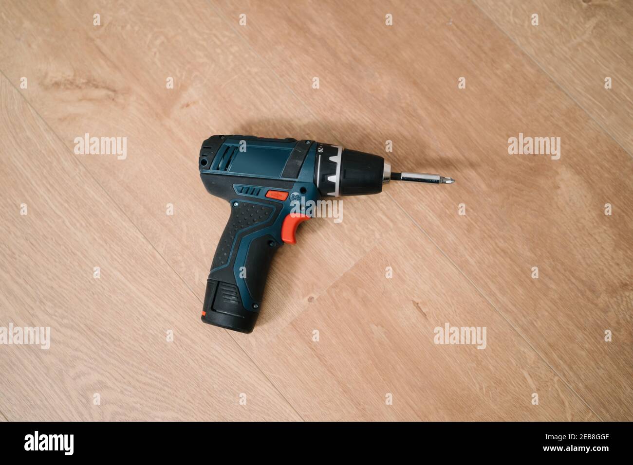 top view of an electric screwdriver on wooden floor Stock Photo - Alamy