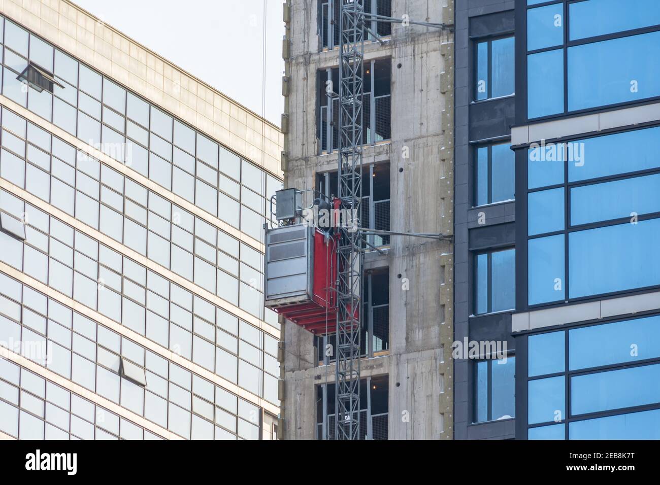 Construction elevator outside the facade of a multi-storey building ...
