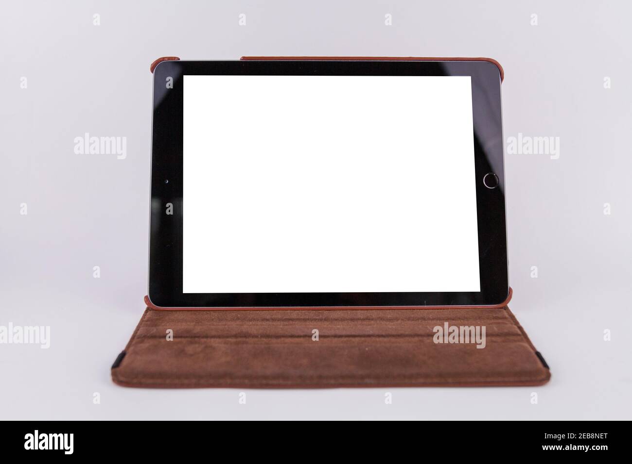 a tablet with white screen on table in office on white background Stock ...