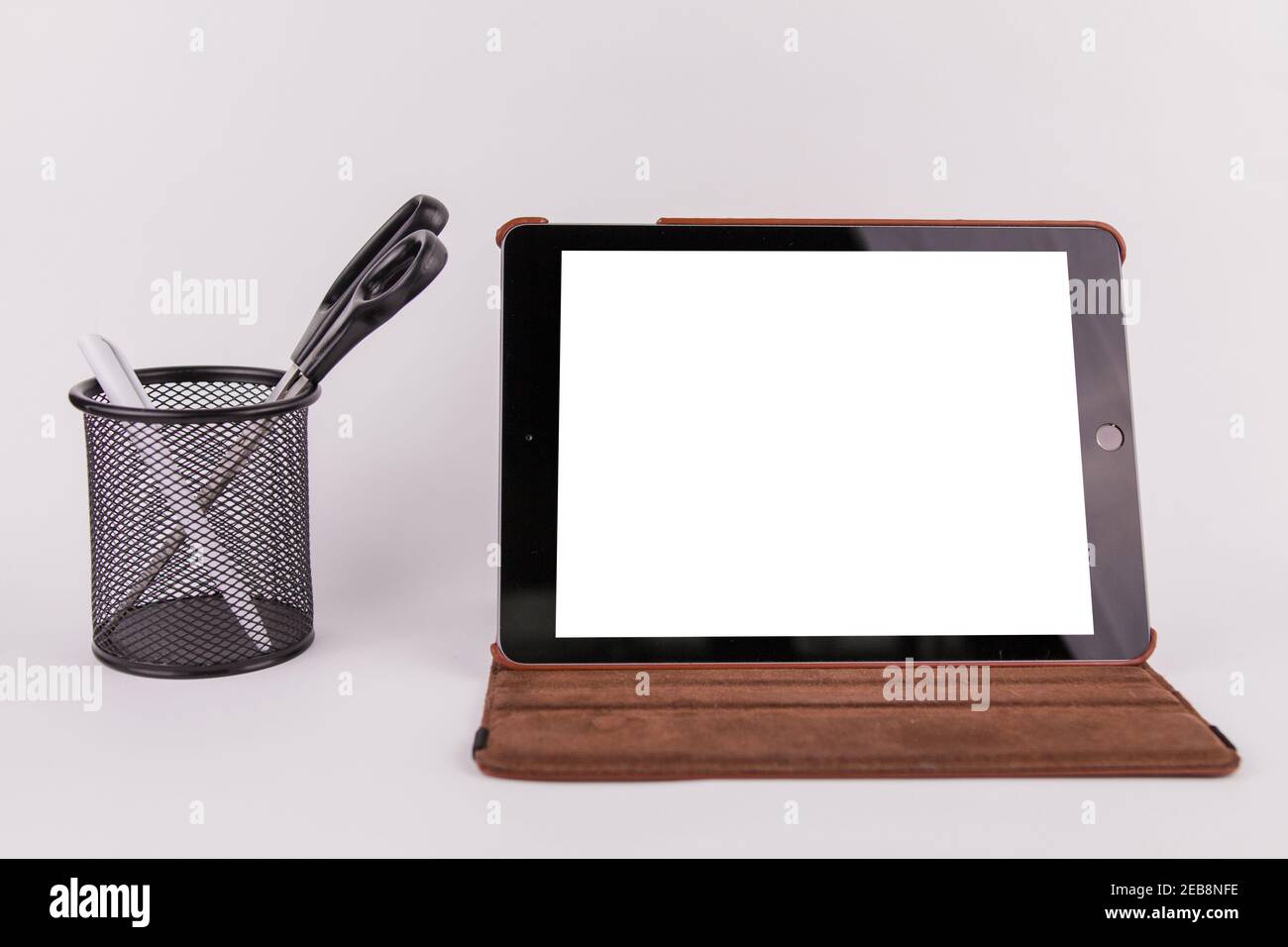 a tablet with white screen on table in office on white background Stock ...