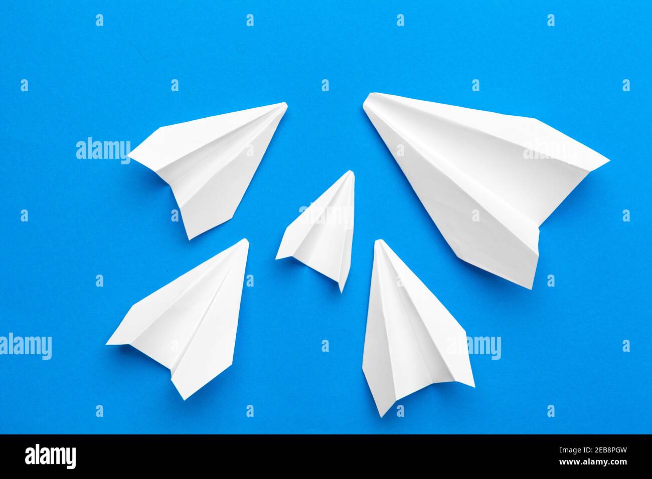 white paper airplane on a navy paper background Stock Photo - Alamy