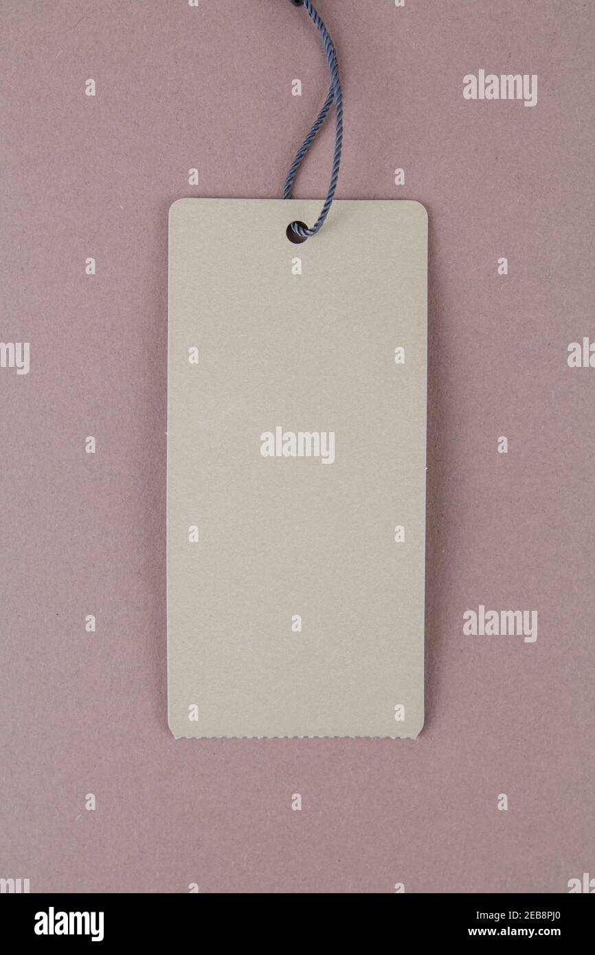 a blank clothing tag on beige background for shopping and price Stock ...