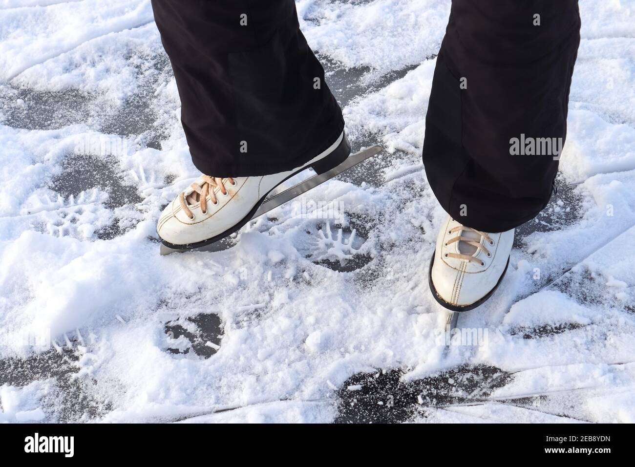 Close up on womans feet wearing ice skating boots and standing on ice ...
