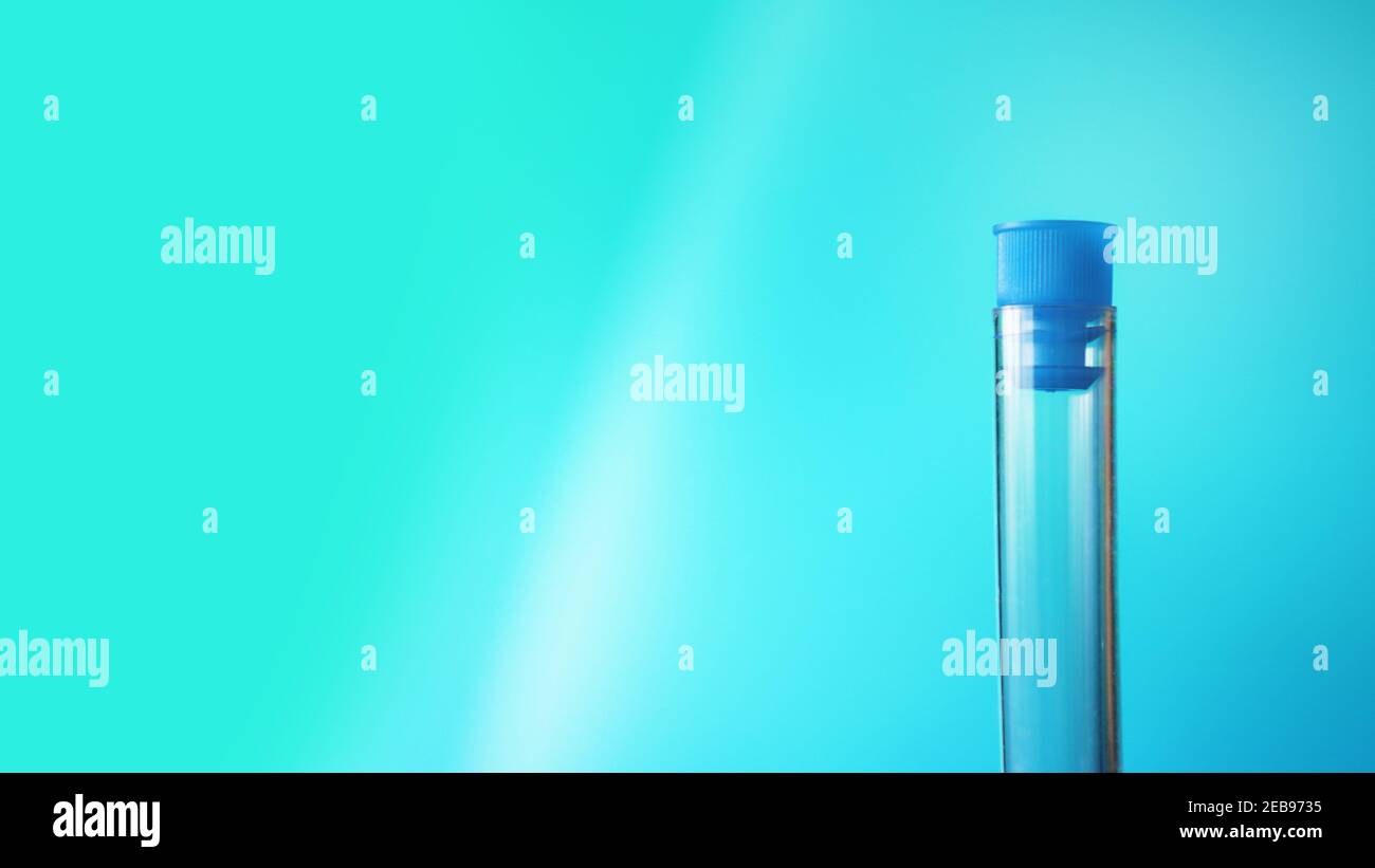 One test tube against blurred blue background Stock Photo - Alamy